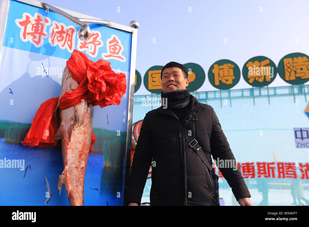 The owner poses with a 23-kilogram fish, which is the biggest catch ...