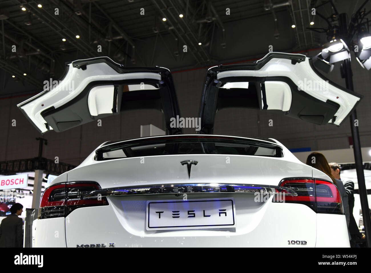 --FILE--People look at the logo at the sales center of Tesla in Jinqiao ...
