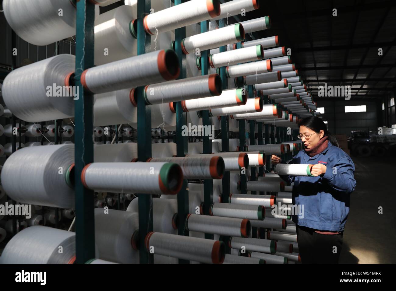 --FILE--A female Chinese worker handles production of plastics at a ...