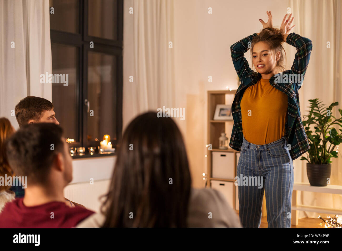 happy friends playing charades at home in evening Stock Photo - Alamy
