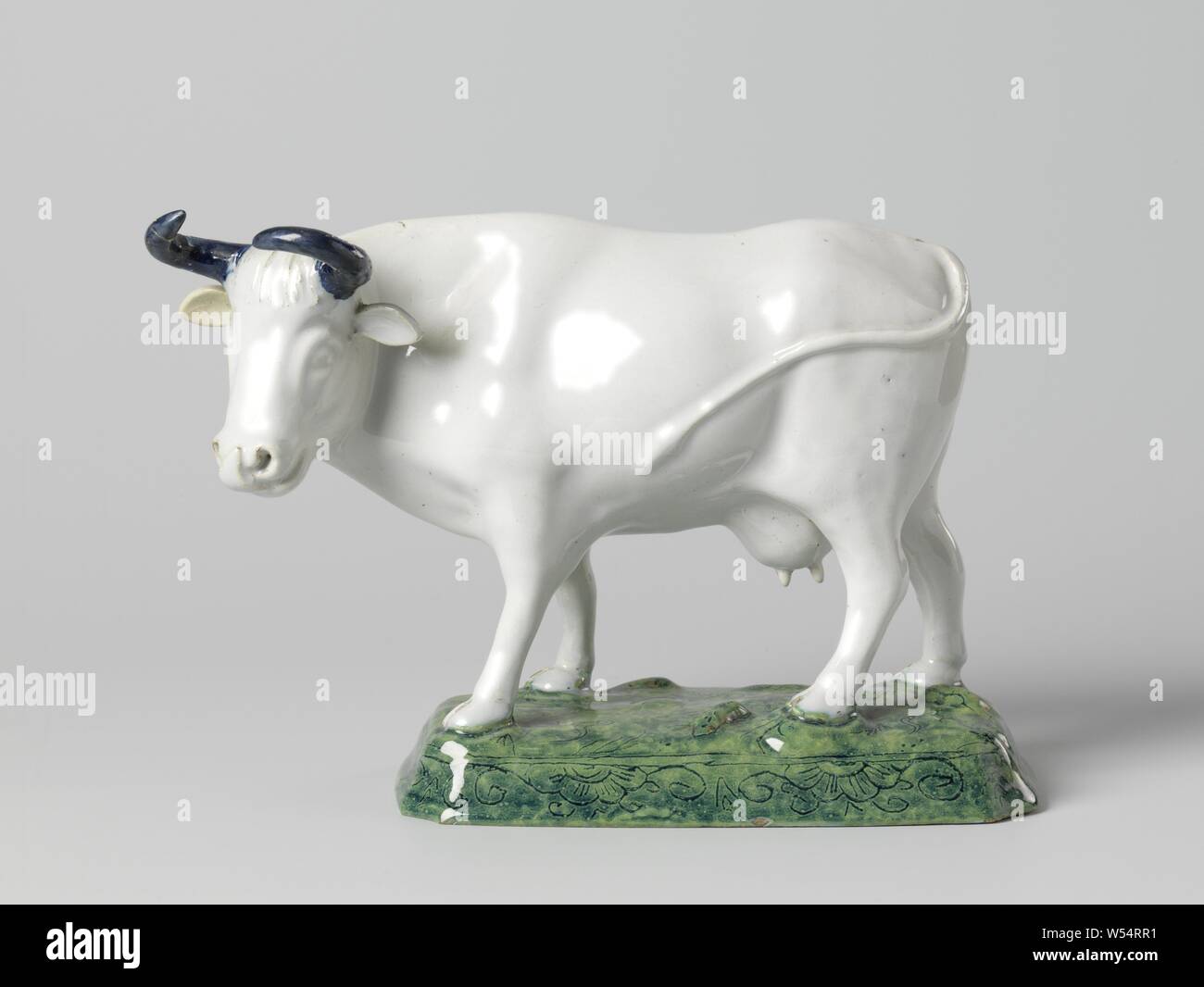 Cow with blue horns, on a rectangular base with beveled corners ...