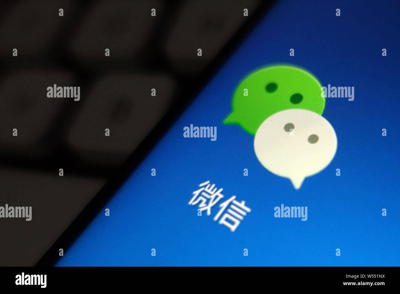 --FILE--A Chinese mobile phone user shows the icon of messaging app ...