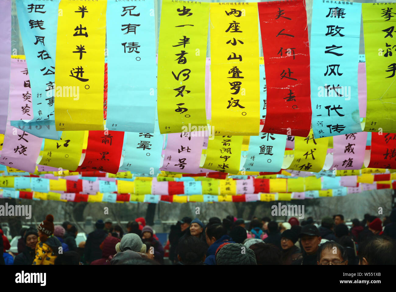 Citizens and tourists try to solve the lantern riddles to celebrate the ...