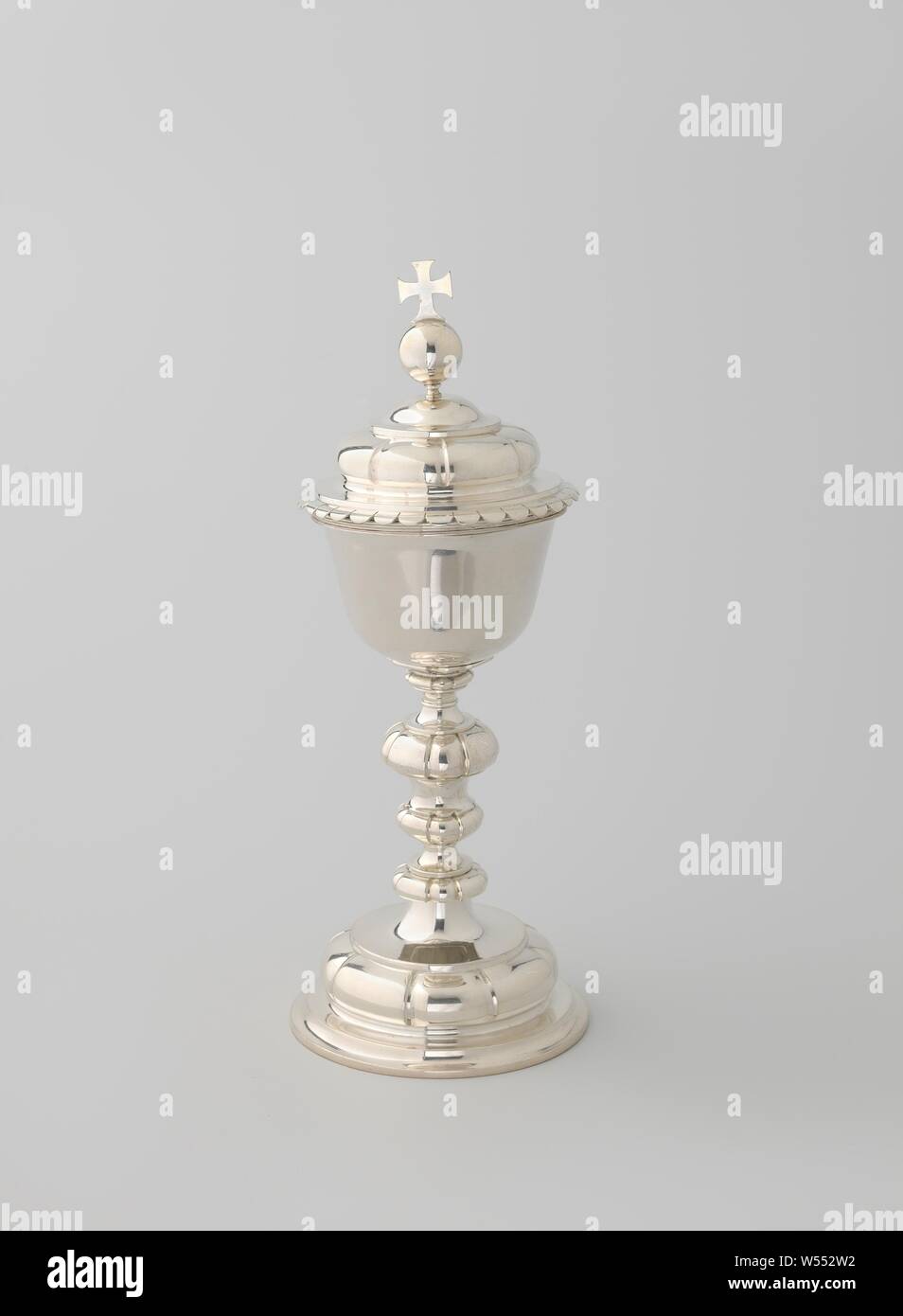 Ciborium of silver with smooth base, stem and lid. On the lid a sphere ...