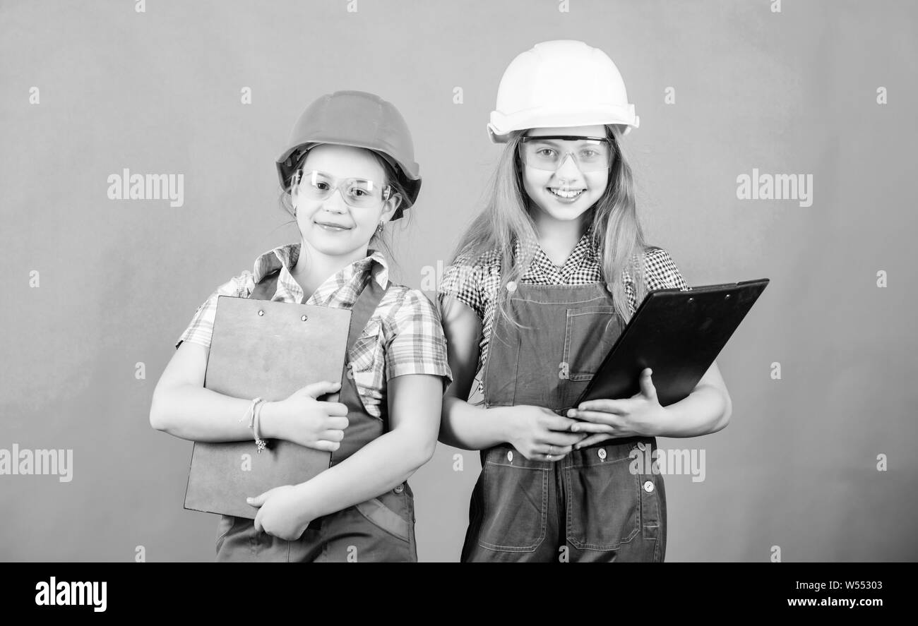 small girls repairing together in workshop. Future profession. Builder ...