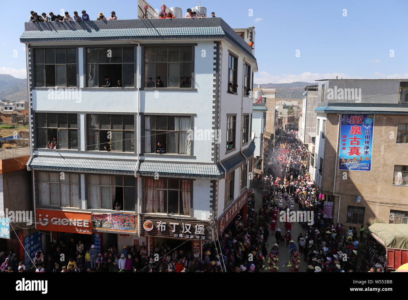 Local residents watch the villagers carrying the "world's largest ...