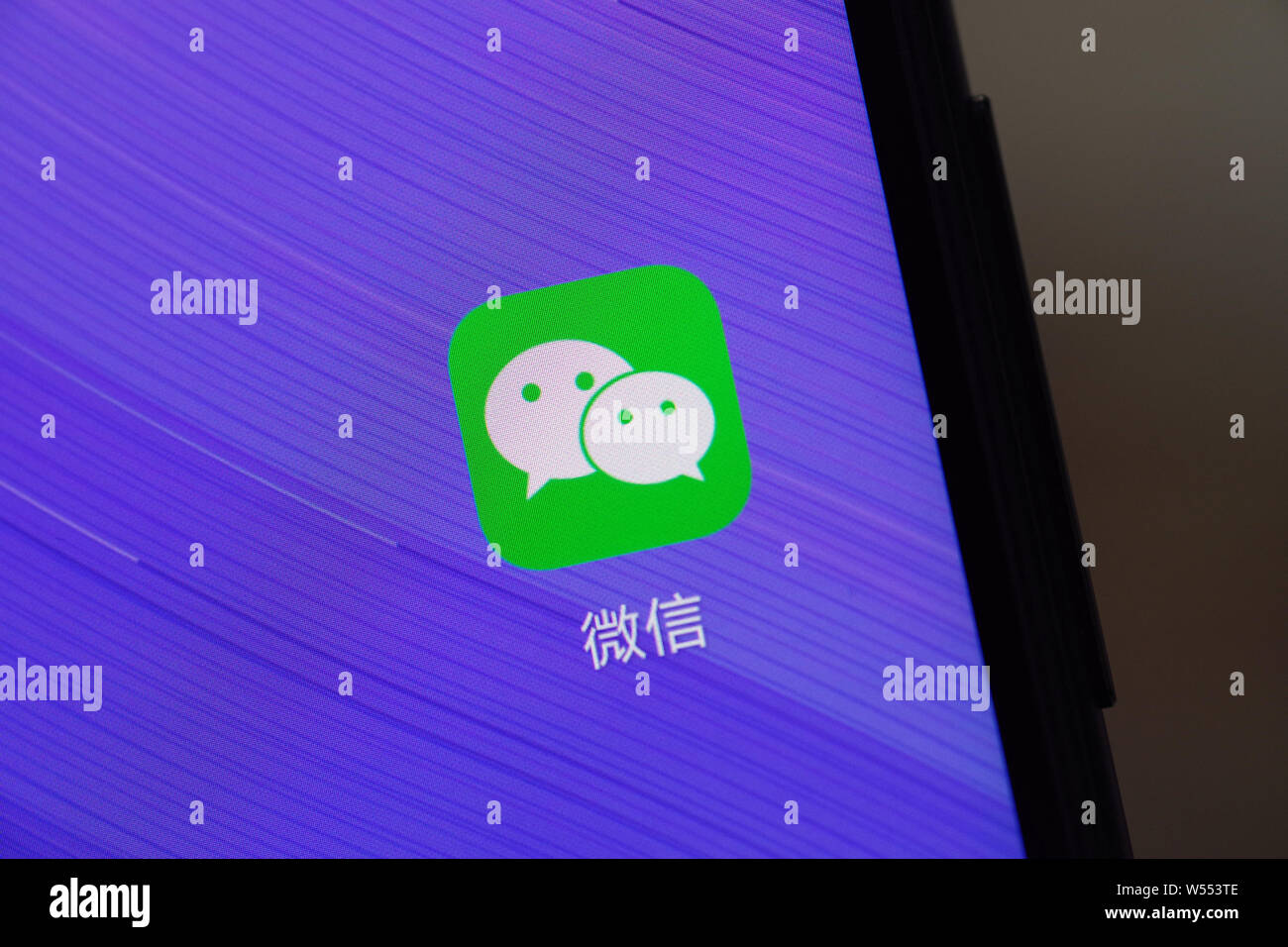 --FILE--A Chinese mobile phone user shows the icon of messaging app ...