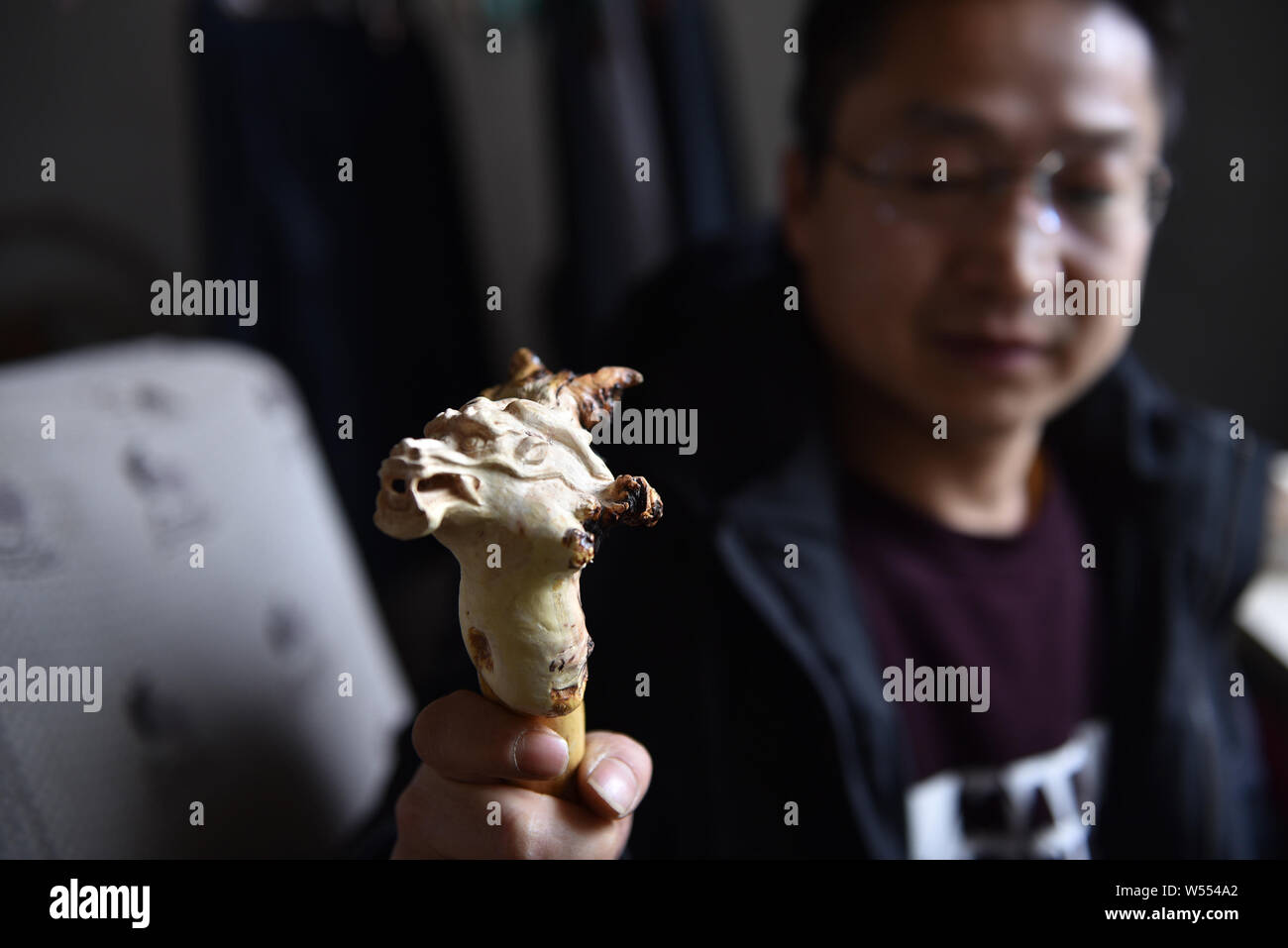 Chinese artist Li Yanjun shows a micro sculpture on a peach pit at his ...