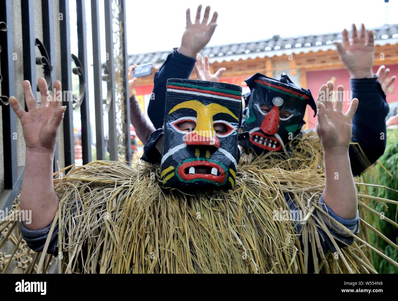 Chinese people of Miao ethnic group wearing masks and grassy cloaks ...