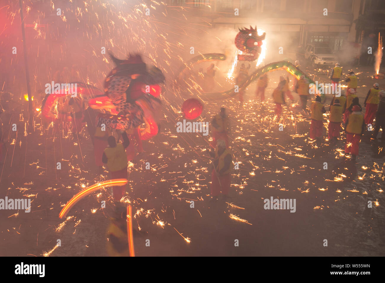 Chinese entertainers perform a fire dragon dance in a shower of molten ...