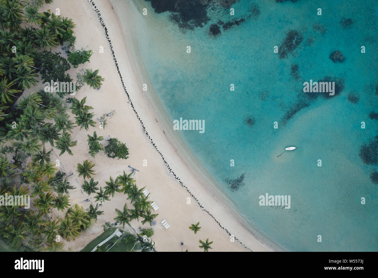 Drone shot of tropical beach with white boat anchored.Samana peninsula ...