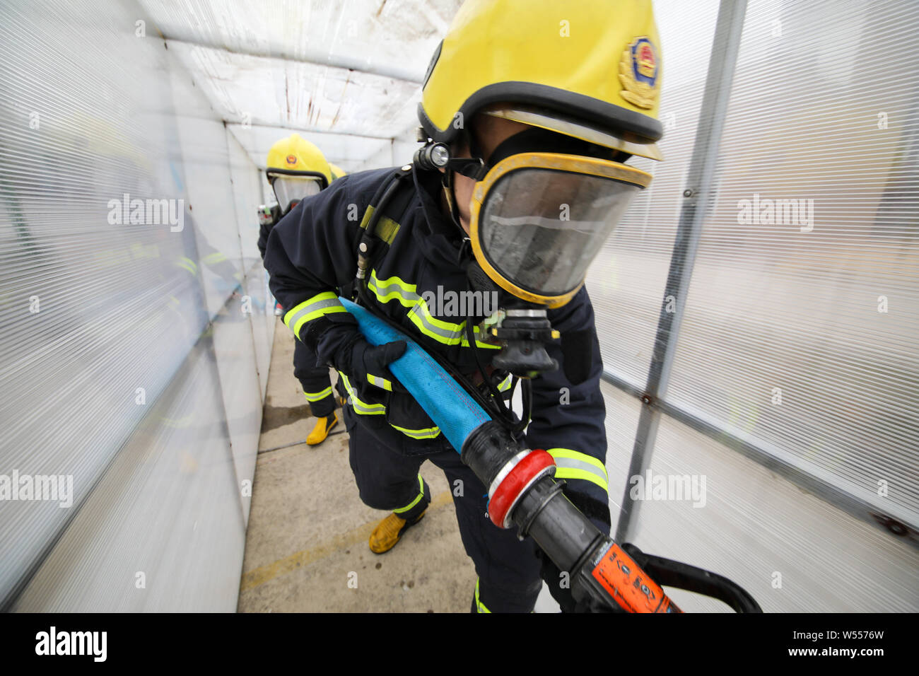 Chinese firefighters spray water to distinguish the fire during a ...