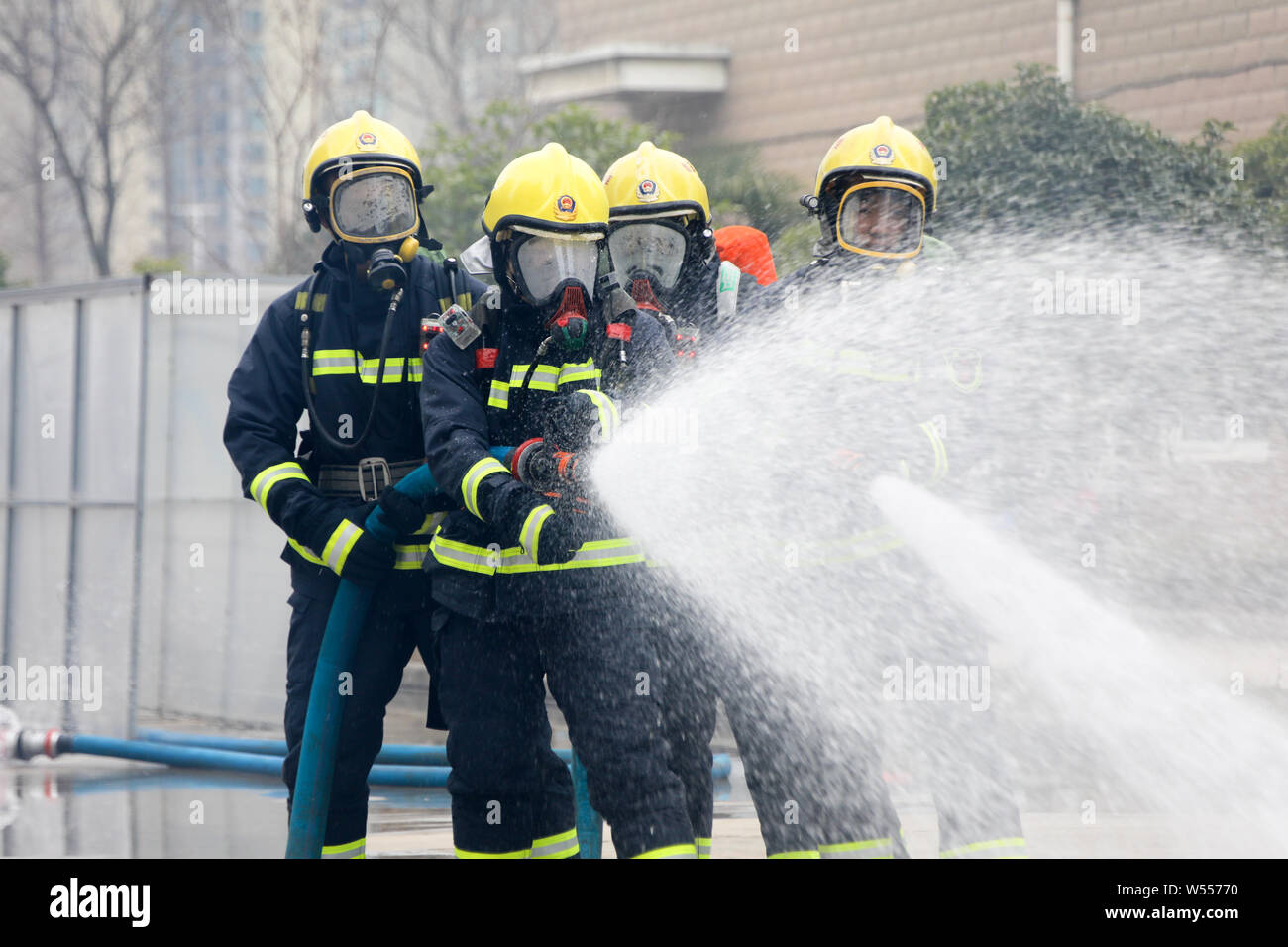 Chinese firefighters spray water to distinguish the fire during a ...