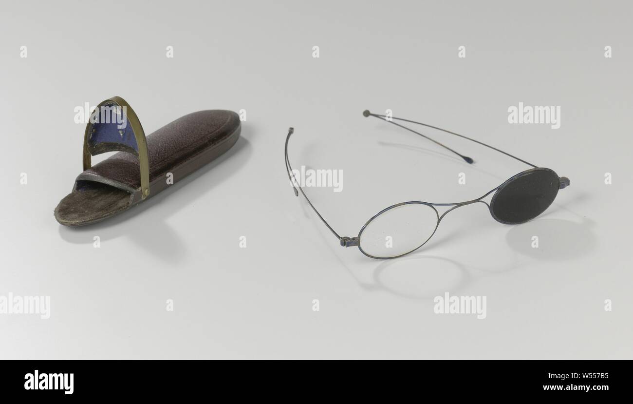 Glasses case in oval shape, leather covered on one side, opening on one ...