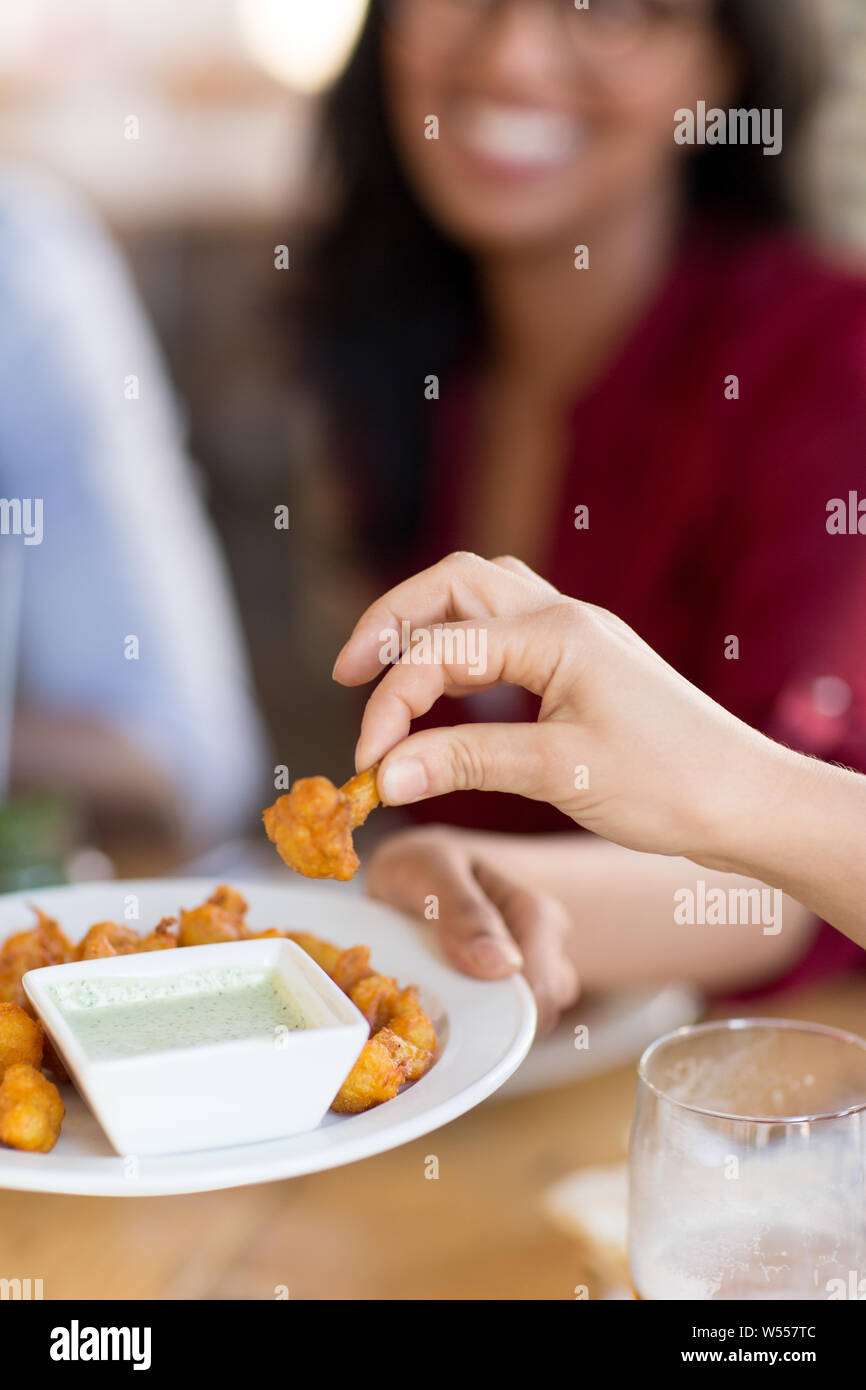 hand with snack and dip sauce at restaurant Stock Photo - Alamy