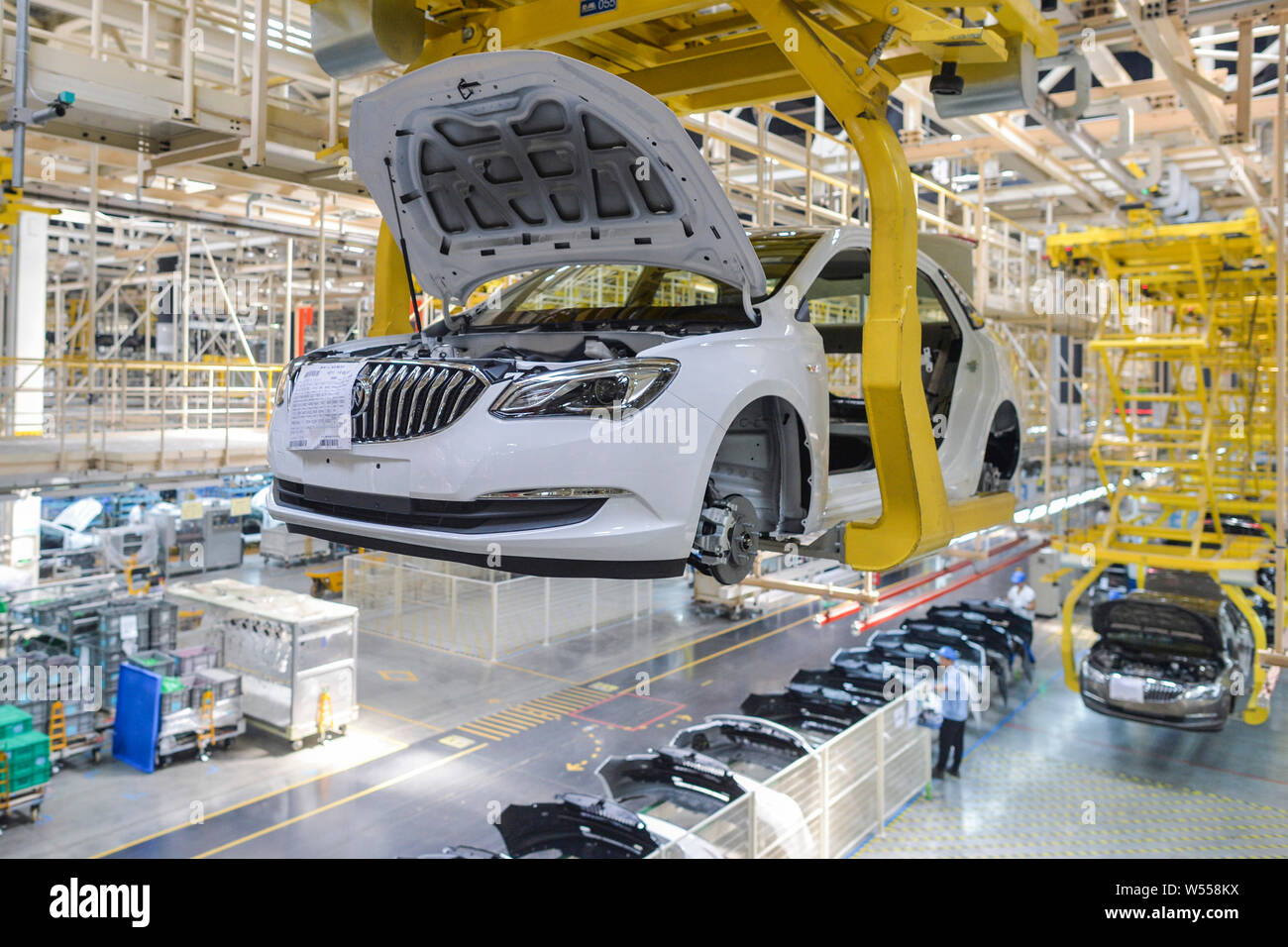 --FILE--Chinese workers assemble cars at an auto plant of SAIC-GM, a ...