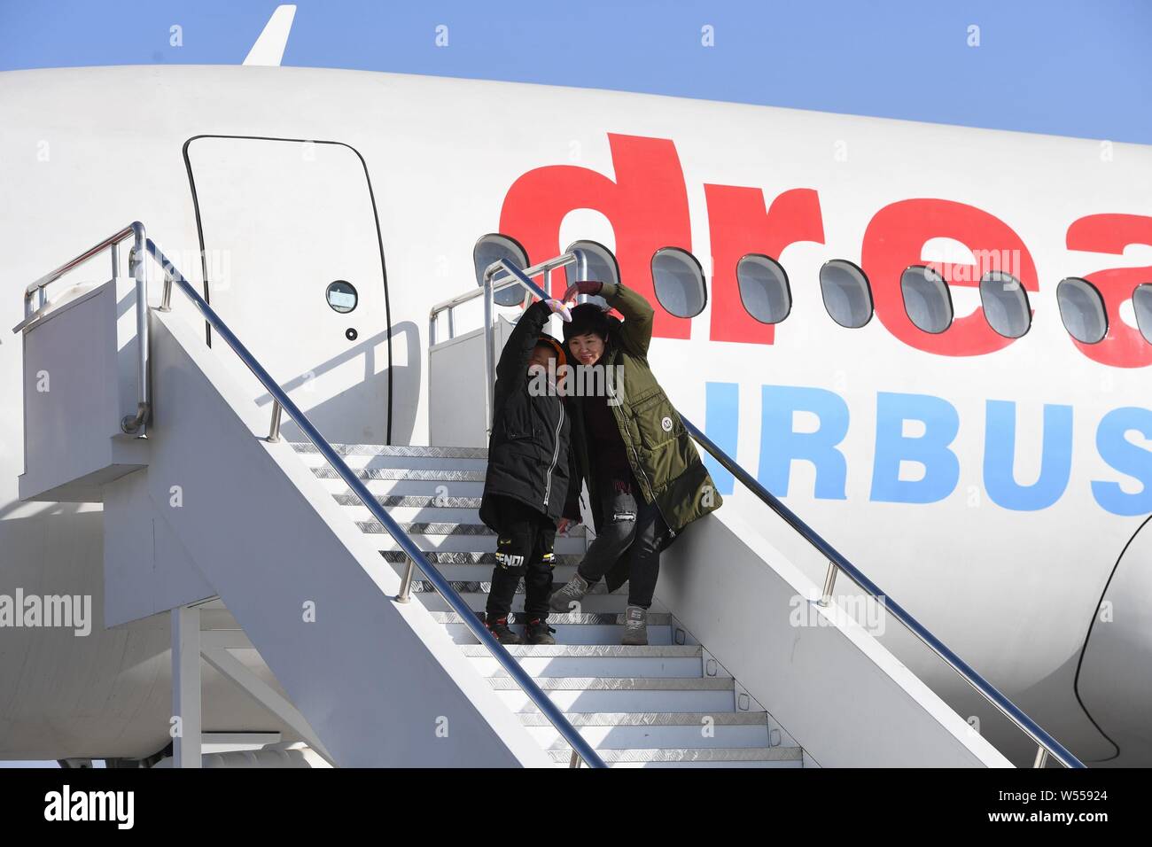 Visitors pose for photos with a full-scale replica of Airbus A320 jet ...