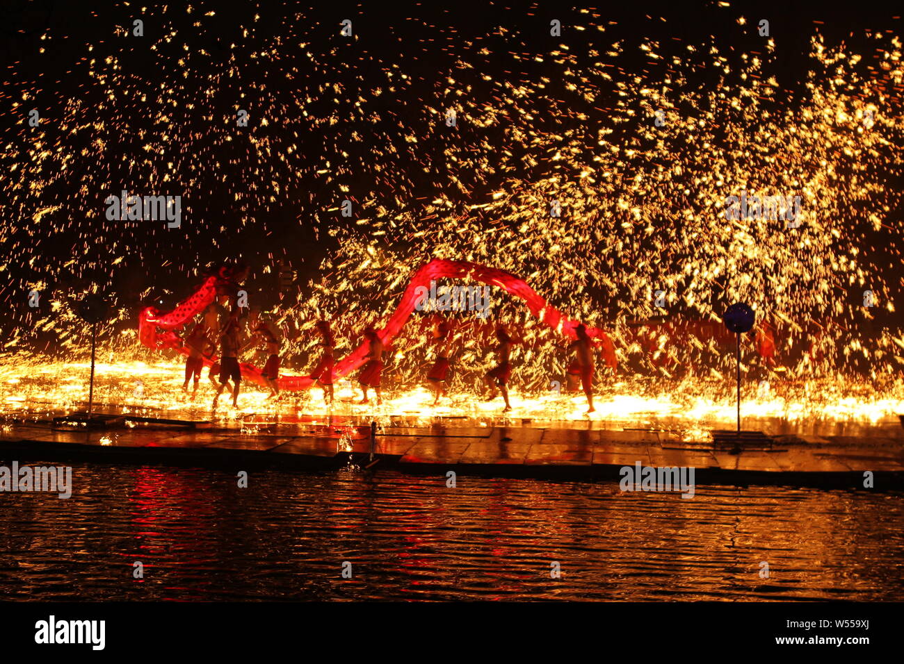 Chinese artists perform dragon dance as sparks created by molten iron ...
