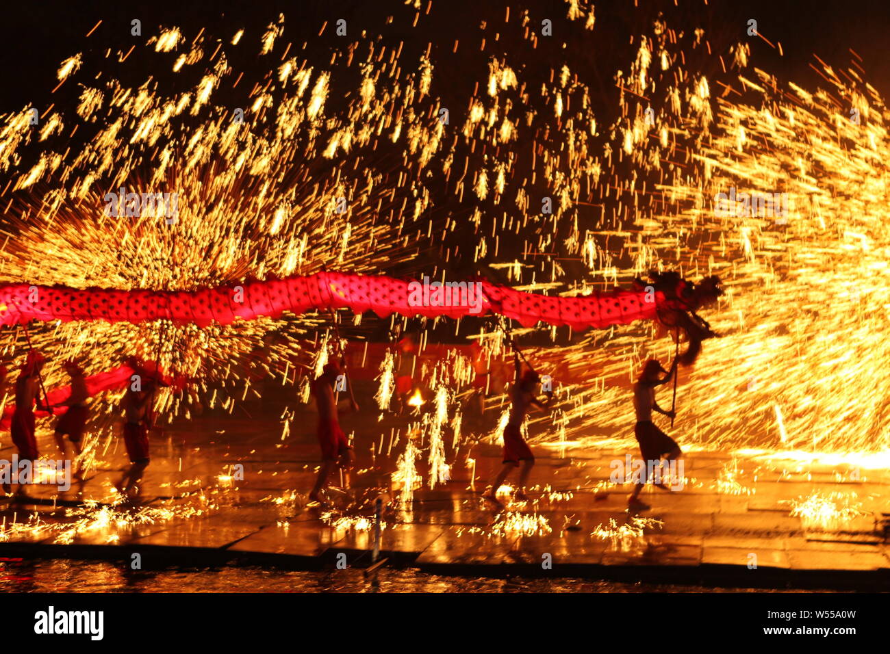 Chinese artists perform dragon dance as sparks created by molten iron ...