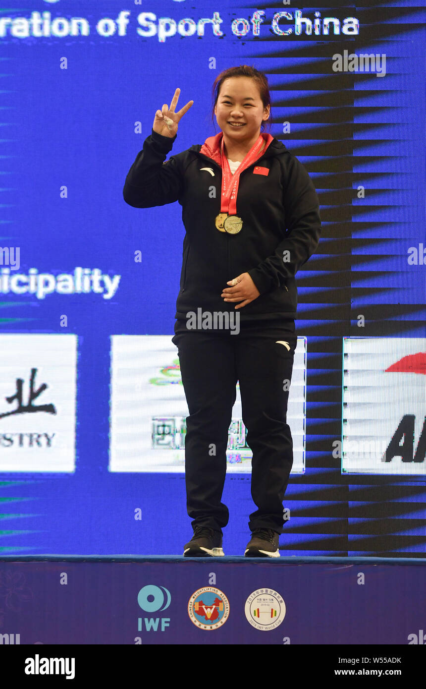 Gold medalist Zhang Wangli of China poses on the podium after winning ...