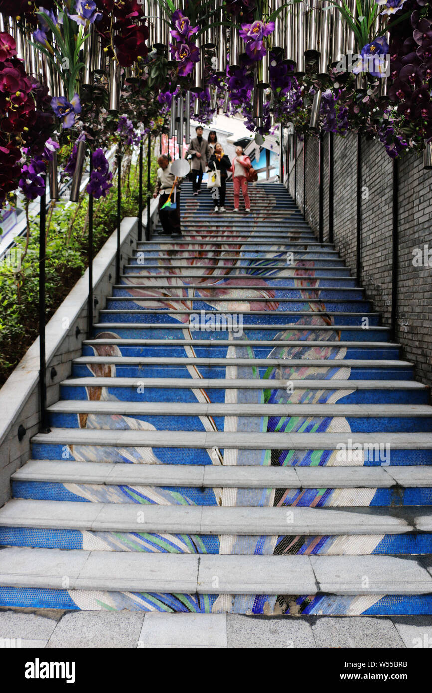 Pedestrians walk on flower painted stairs in Nan'an district, Chongqing ...