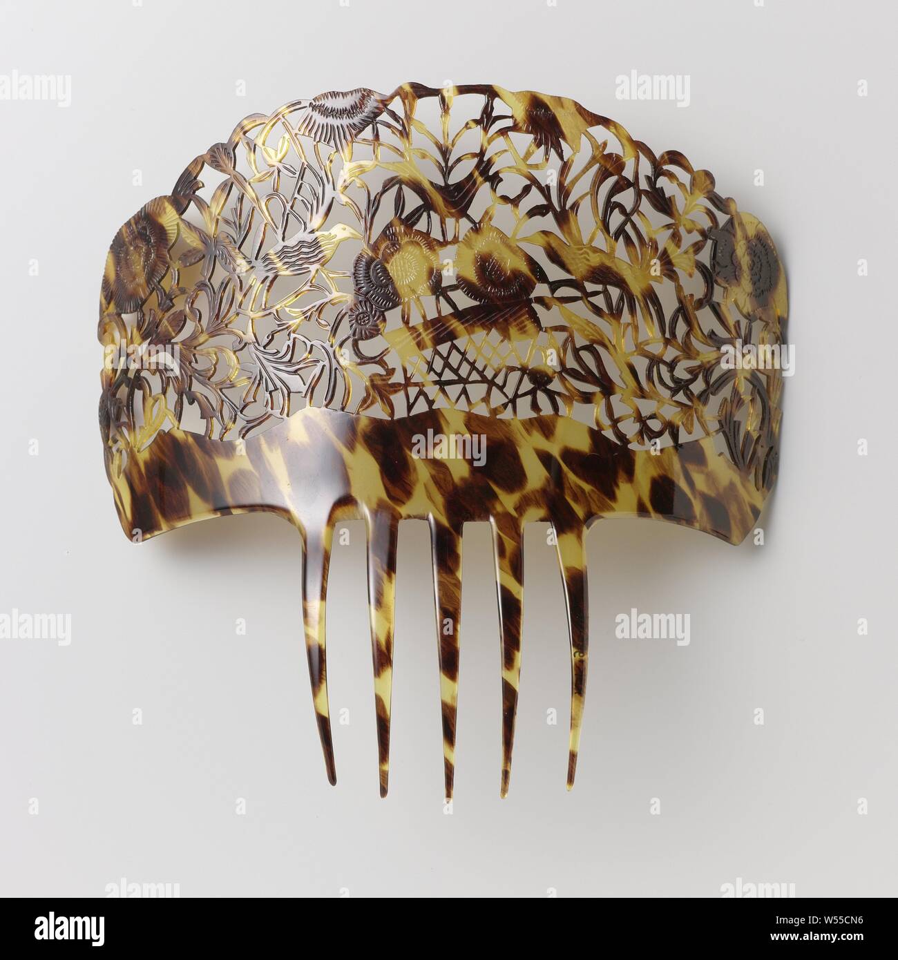 Hair comb of imitation turtle with large ajour cut back with embossed ...