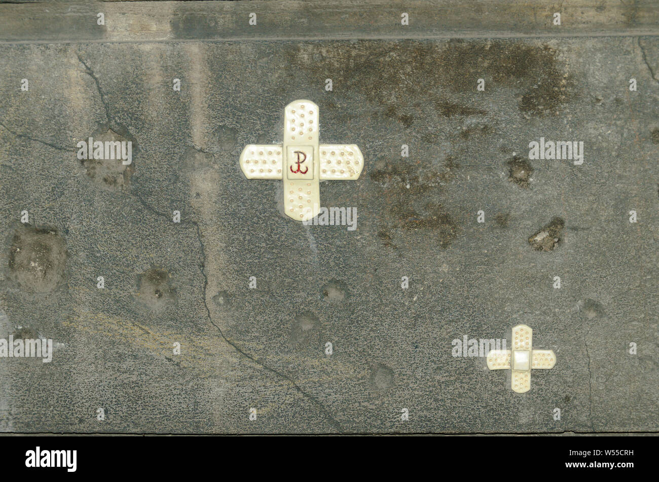 Bullet holes with band aids with the Kotiwica symbol Stock Photo - Alamy