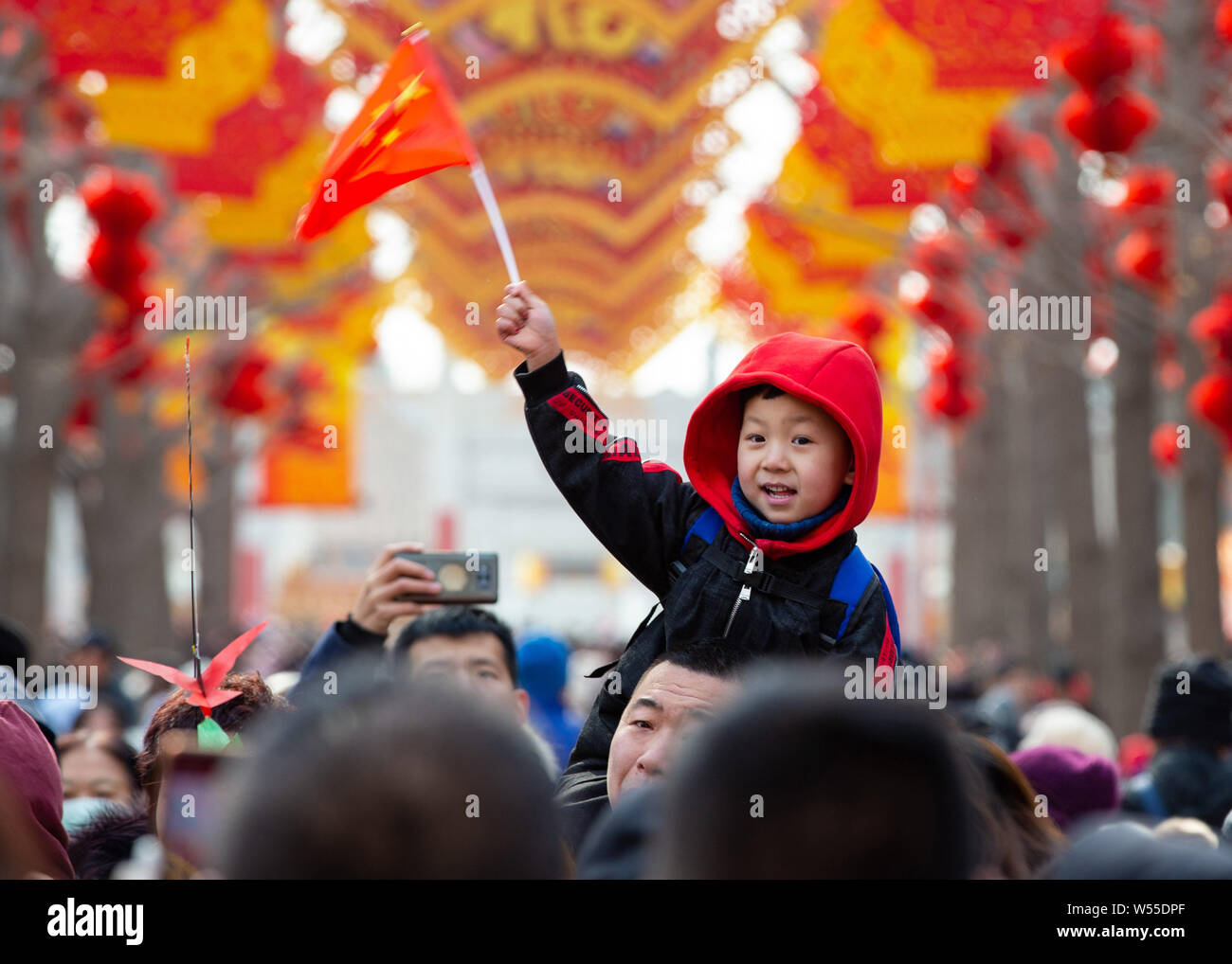 A young child has fun while attending a temple fair at Ditan Park ...