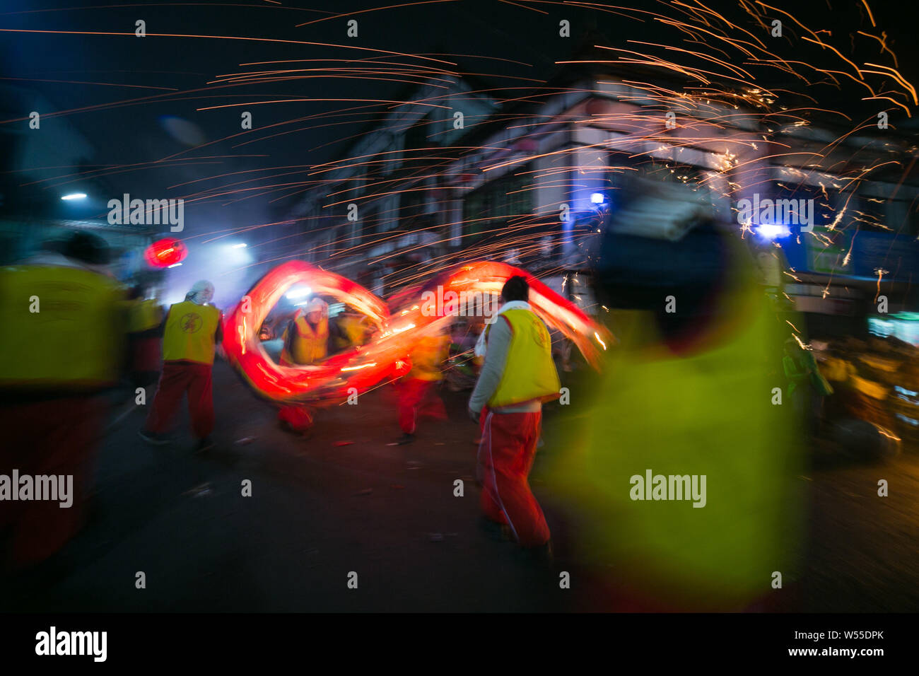 Chinese entertainers perform a fire dragon dance in a shower of molten ...