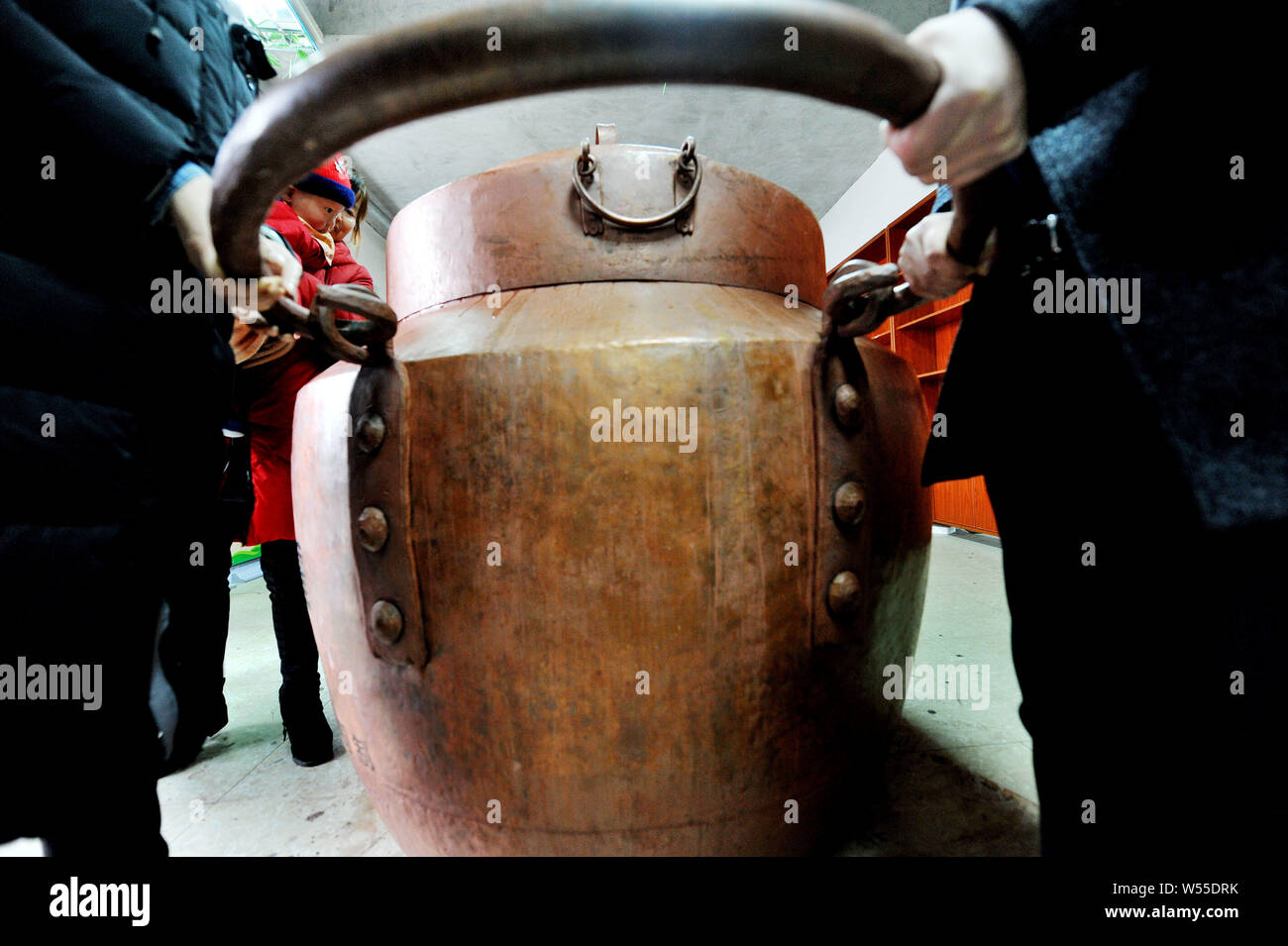 Visitors look at a huge copper pot able to boil 10,000 zongzi, a ...