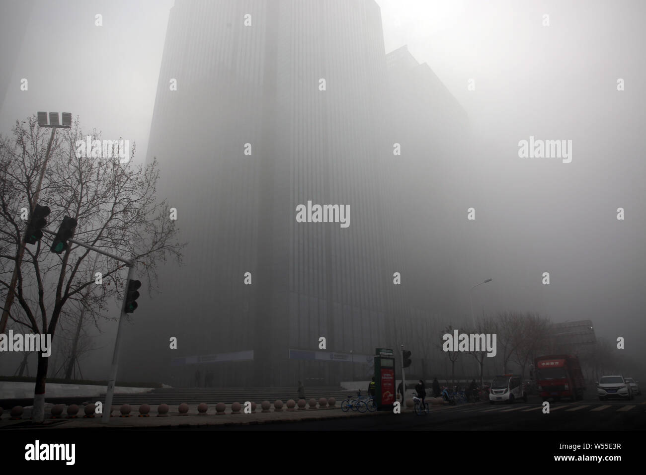 Cars drive on a road in heavy fog in Zhengzhou city, central China's ...