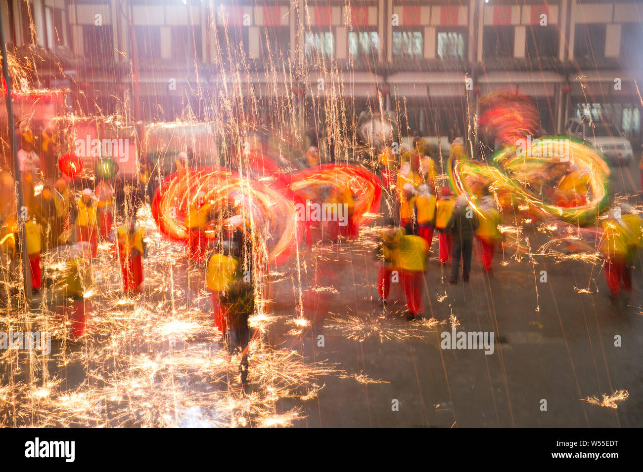 Chinese entertainers perform a fire dragon dance in a shower of molten ...
