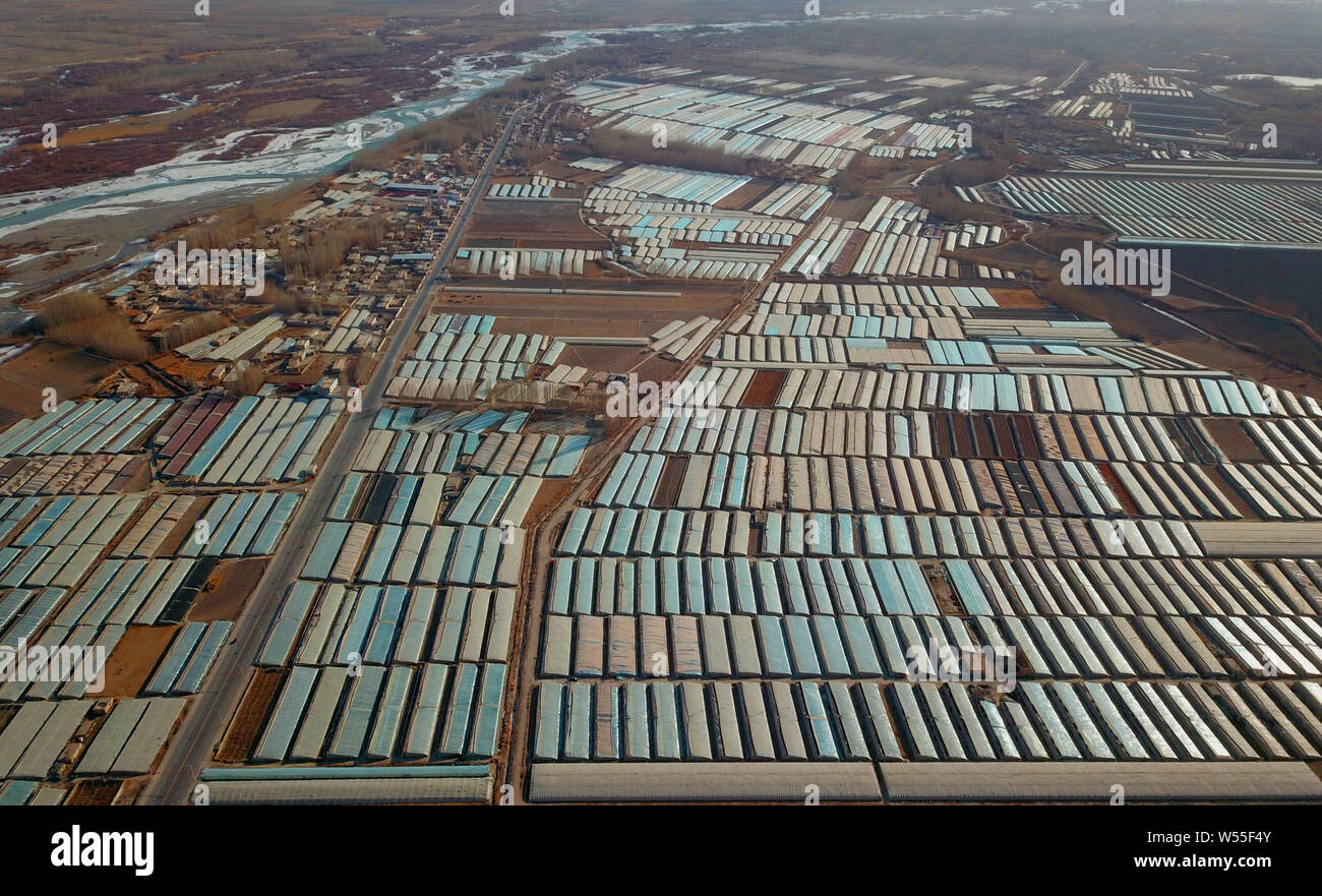 Aerial view of the greenhouses lined up in rows in Hejing county ...