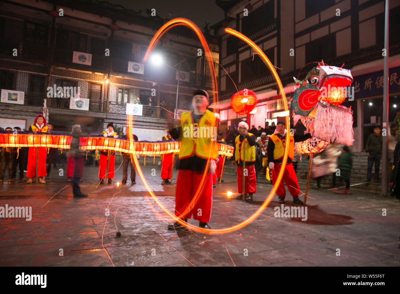 Chinese entertainers perform a fire dragon dance in a shower of molten ...