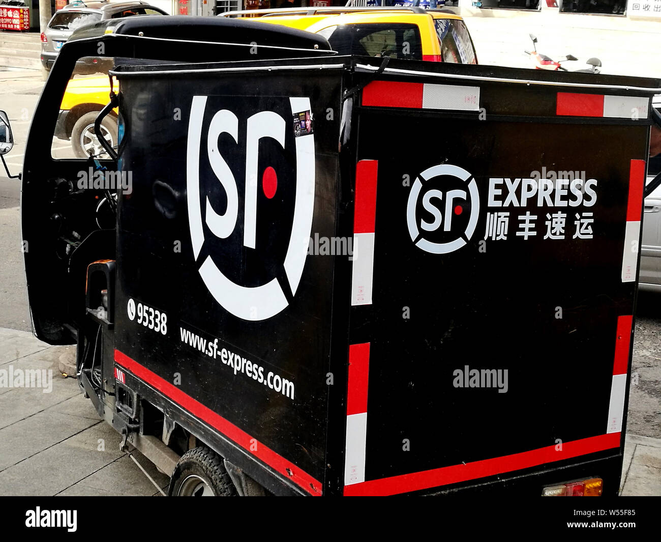 --FILE--A delivery tricycle of SF Express is seen on a road in Huaibei ...