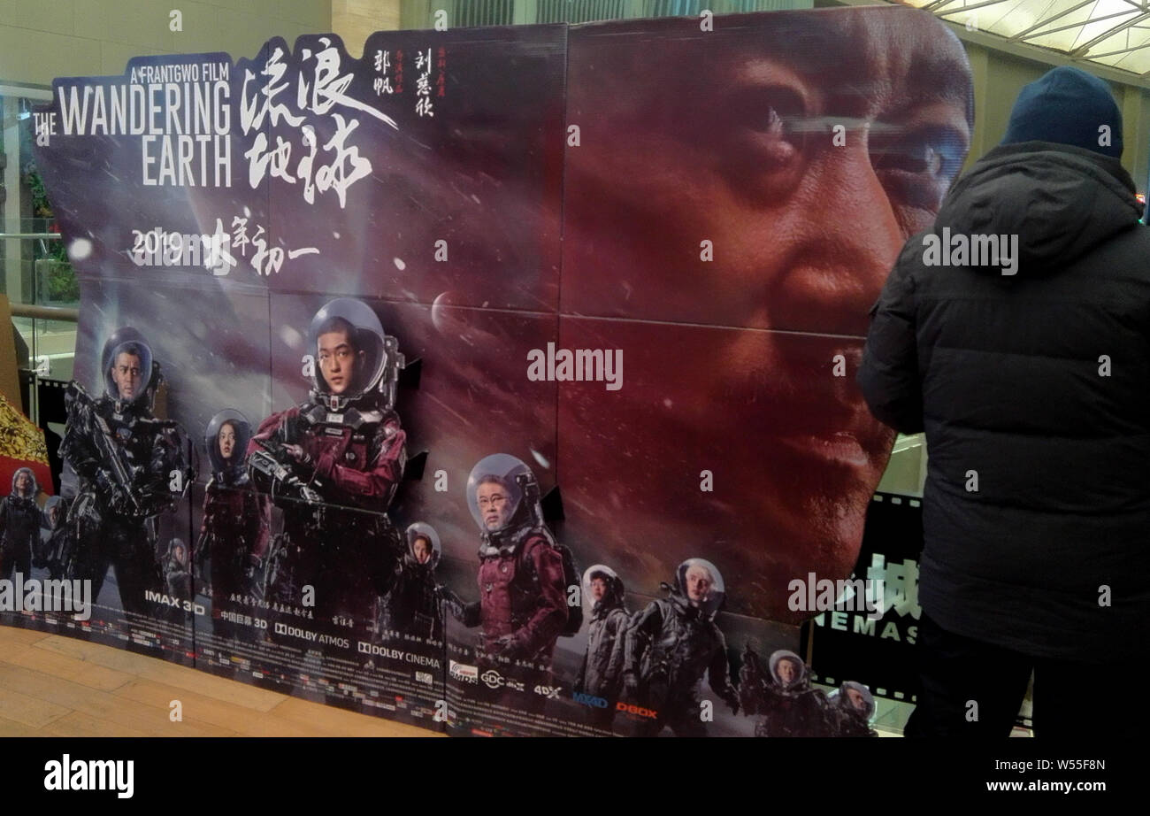 --FILE--A Chinese filmgoer looks at a poster of the movie "The ...