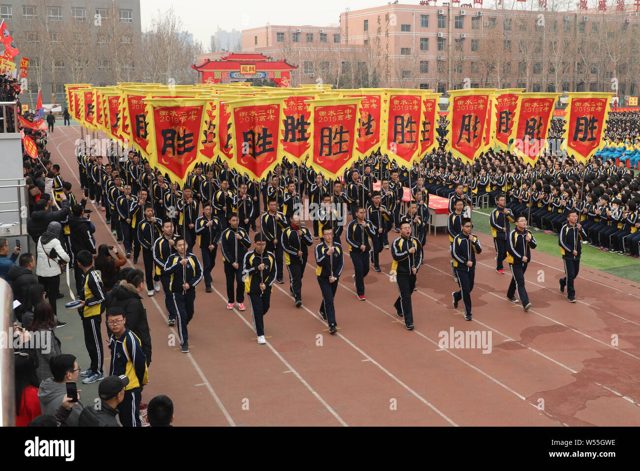 Chinese students queue up in lines during a mass rally for the upcoming ...