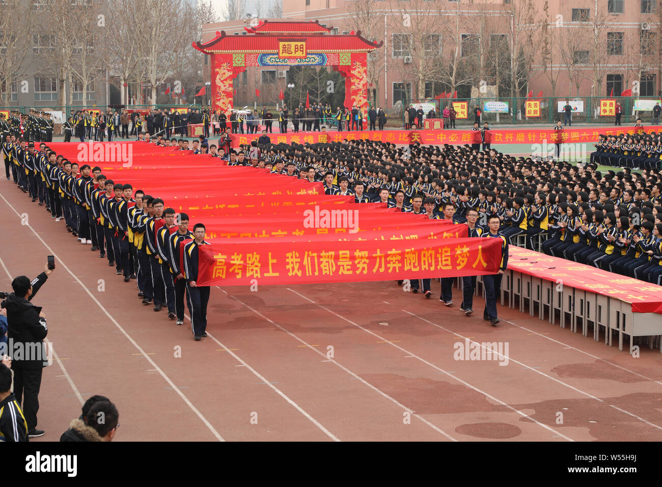 Chinese students queue up in lines during a mass rally for the upcoming ...