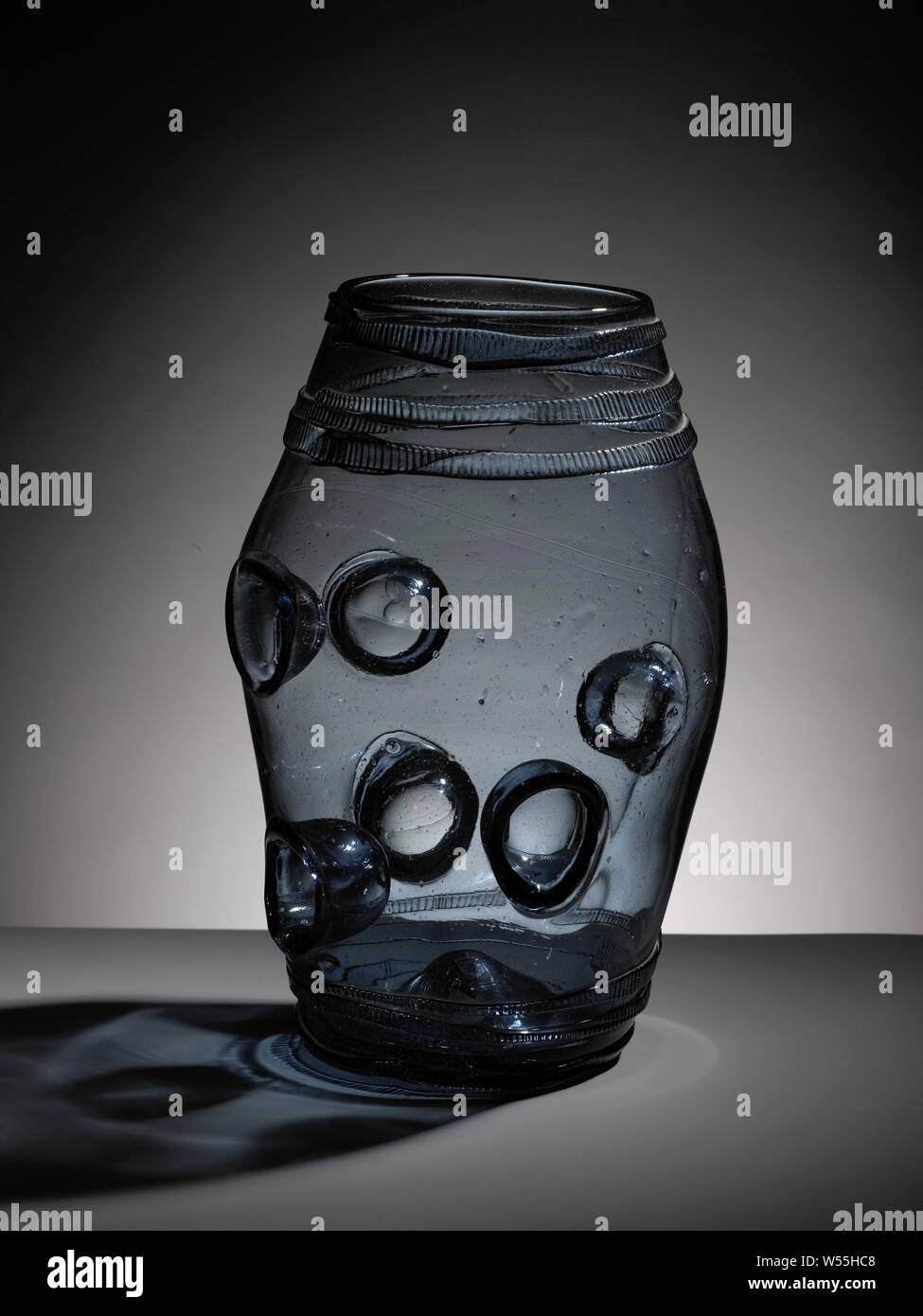Thumb glass, Thumb glass of blue glass with a curved bottom. Body ...