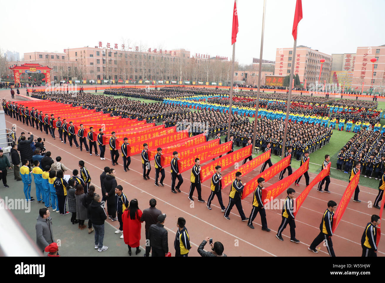 Chinese students queue up in lines during a mass rally for the upcoming ...