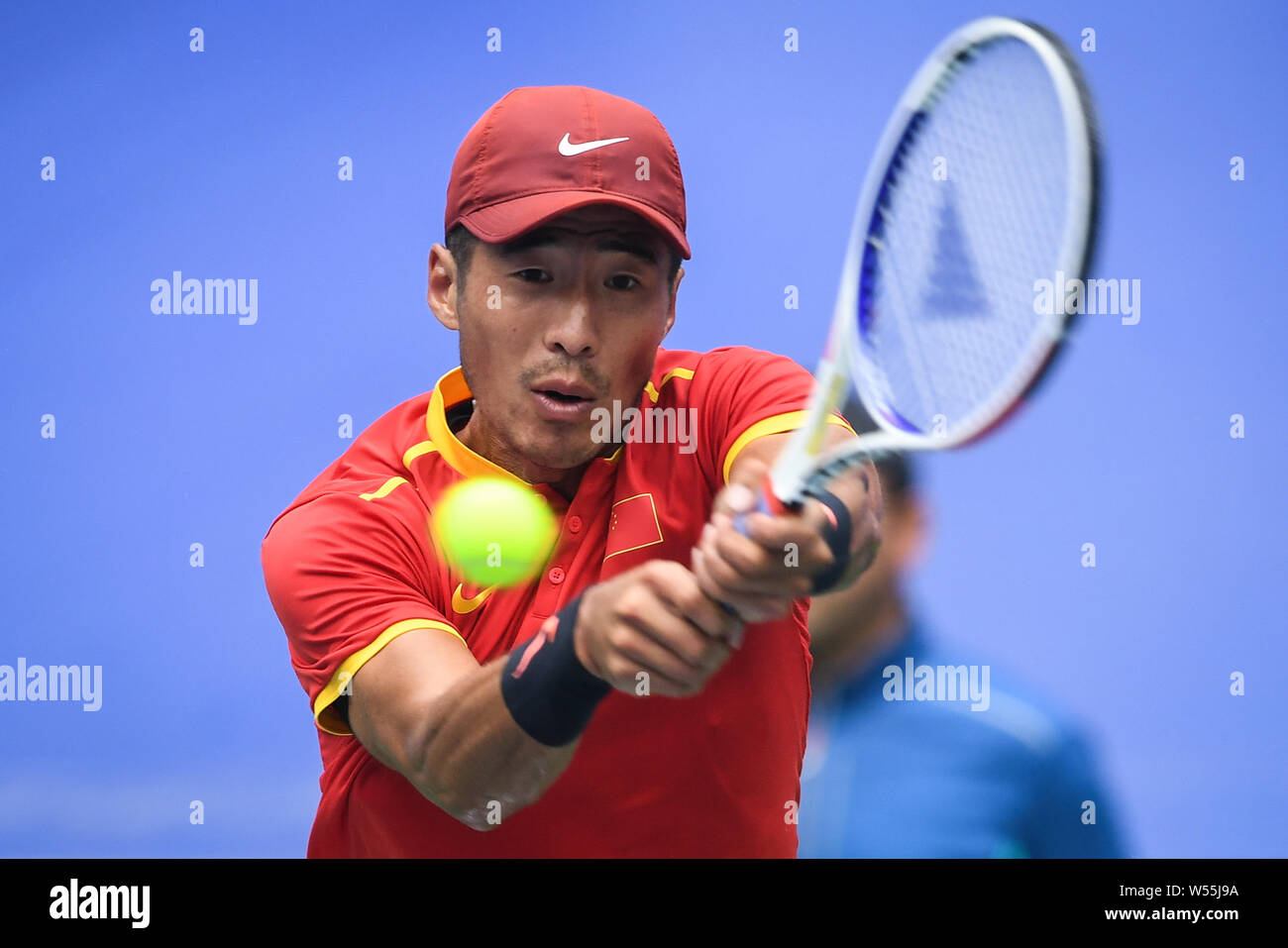 Li Zhe of China returns a shot to Taro Daniel of Japan during the Davis ...