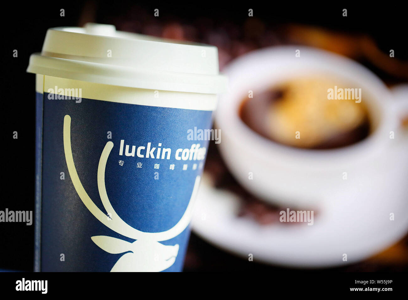 --FILE--A customer shows a cup of Luckin Coffee at a store of China's ...