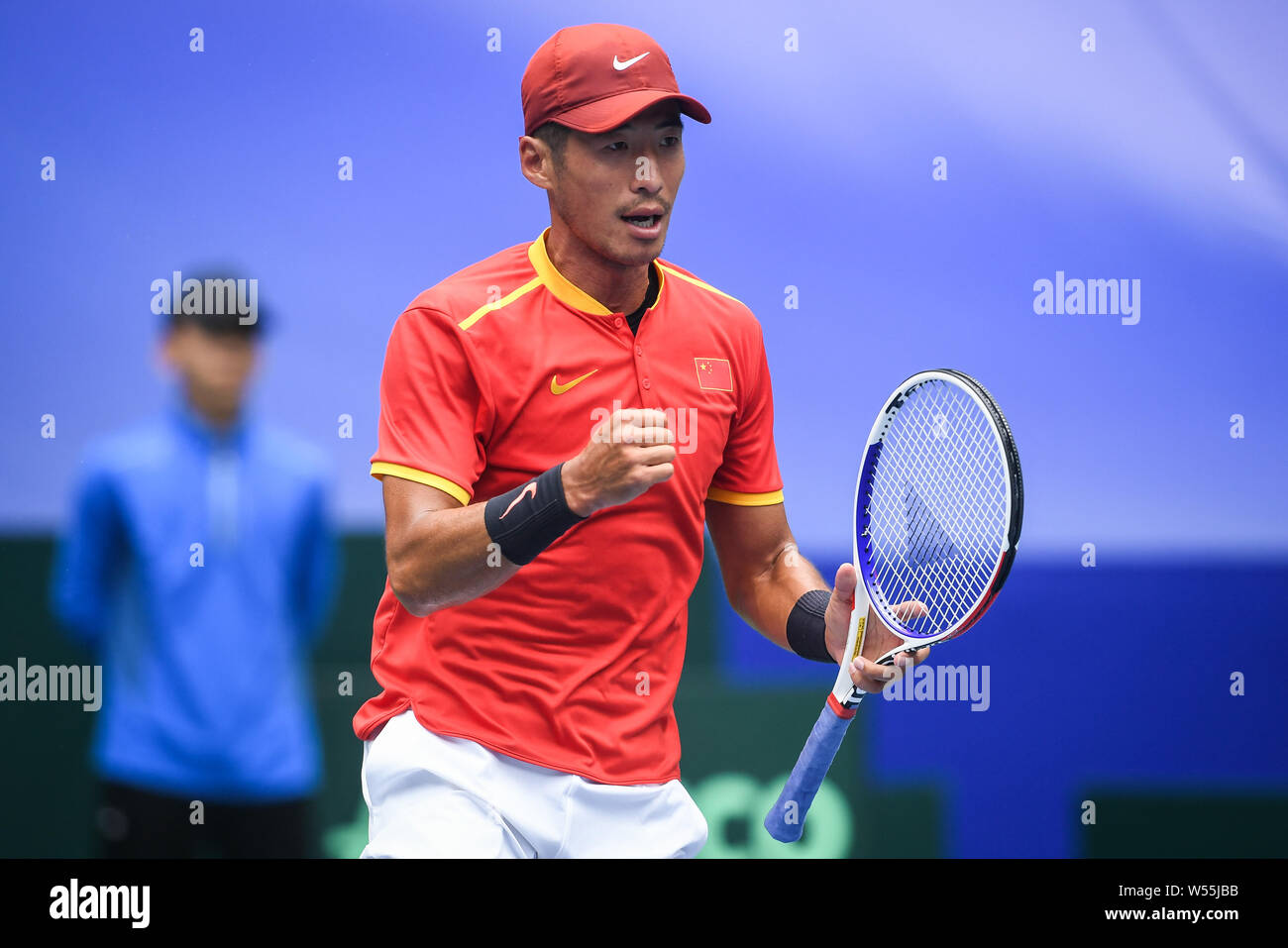 Li Zhe of China reacts after scoring against Taro Daniel of Japan ...