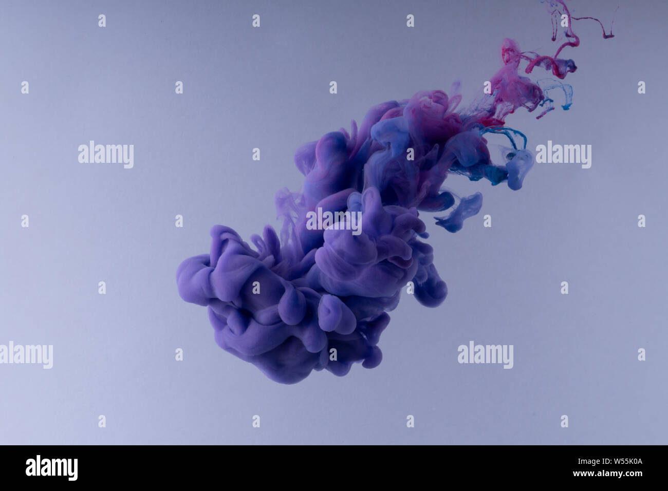 Colorful Ink swirling in water. Cloud of silky ink on white background ...