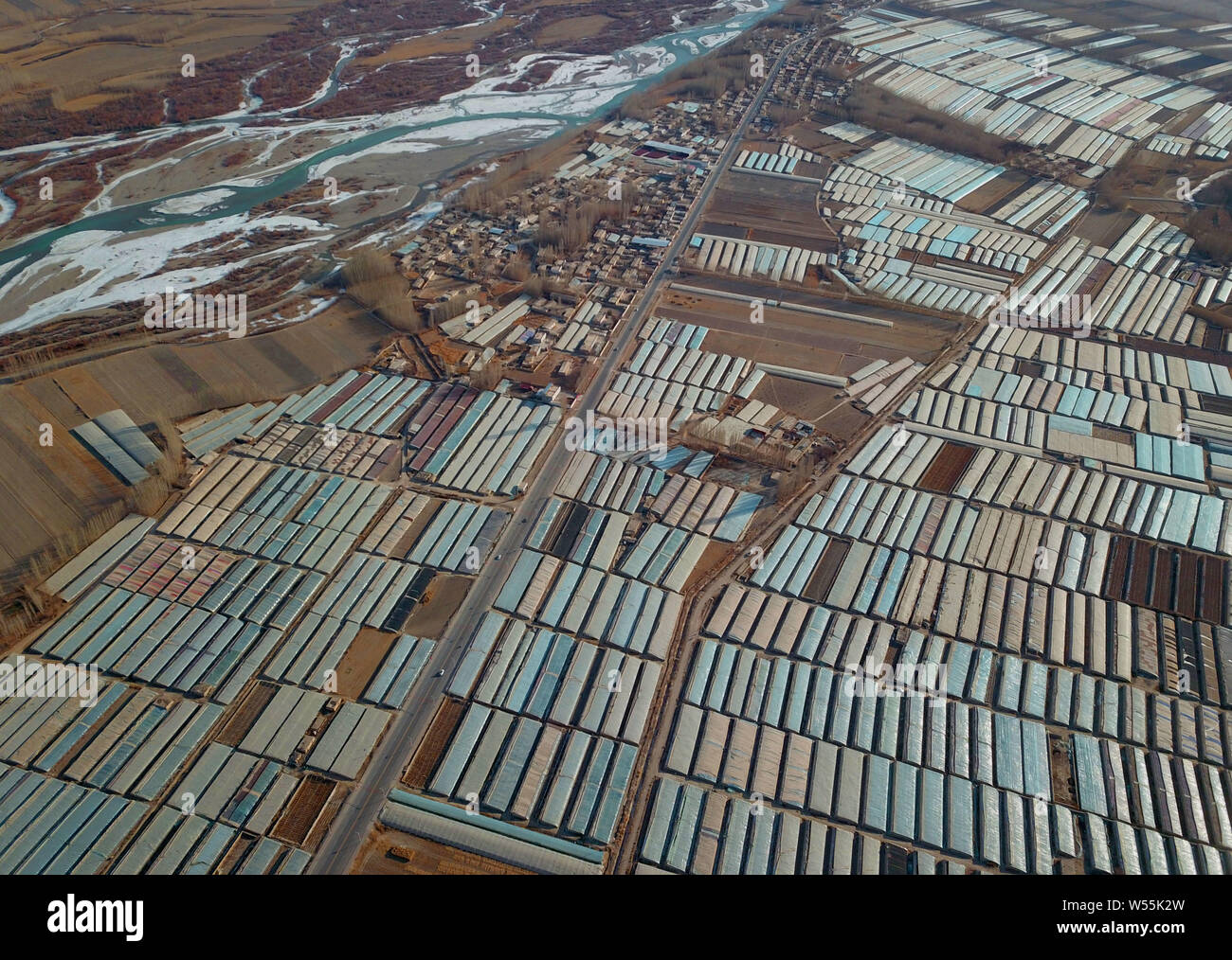 Aerial view of the greenhouses lined up in rows in Hejing county ...