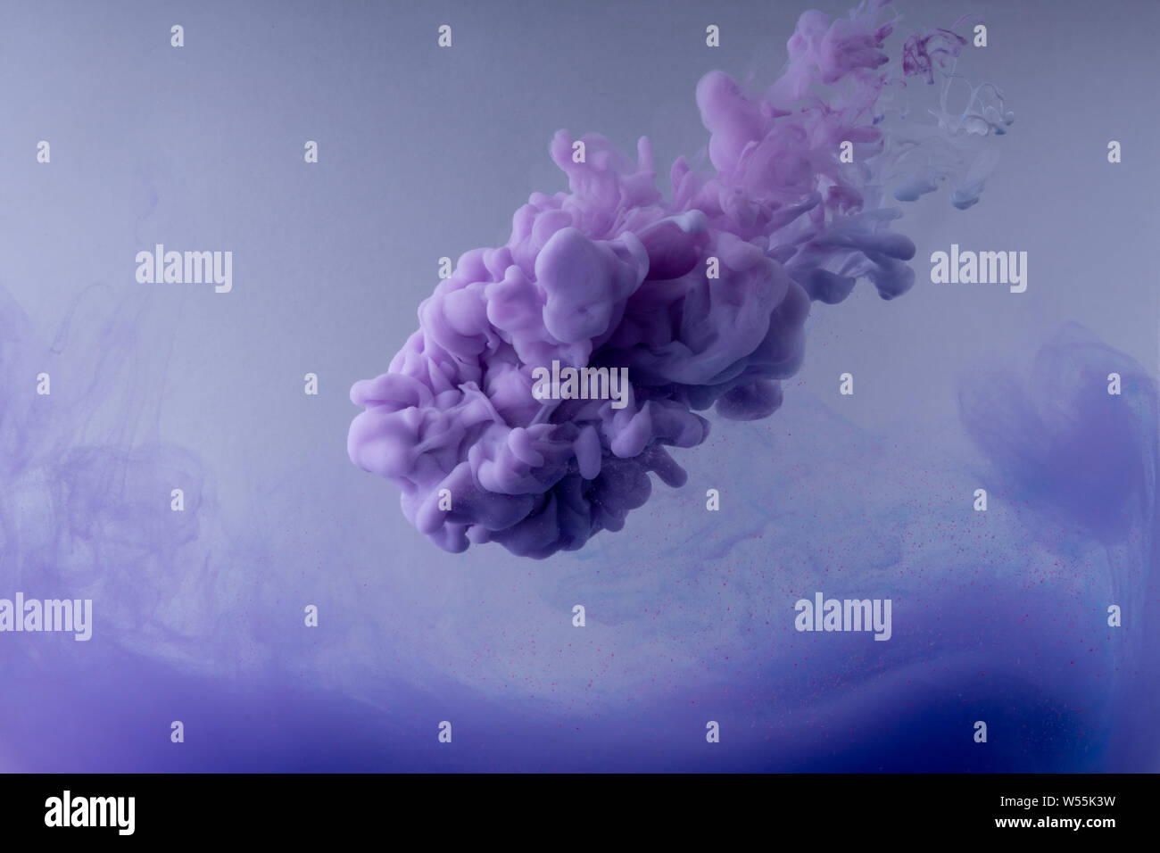 Colorful Ink swirling in water. Cloud of silky ink on white background ...