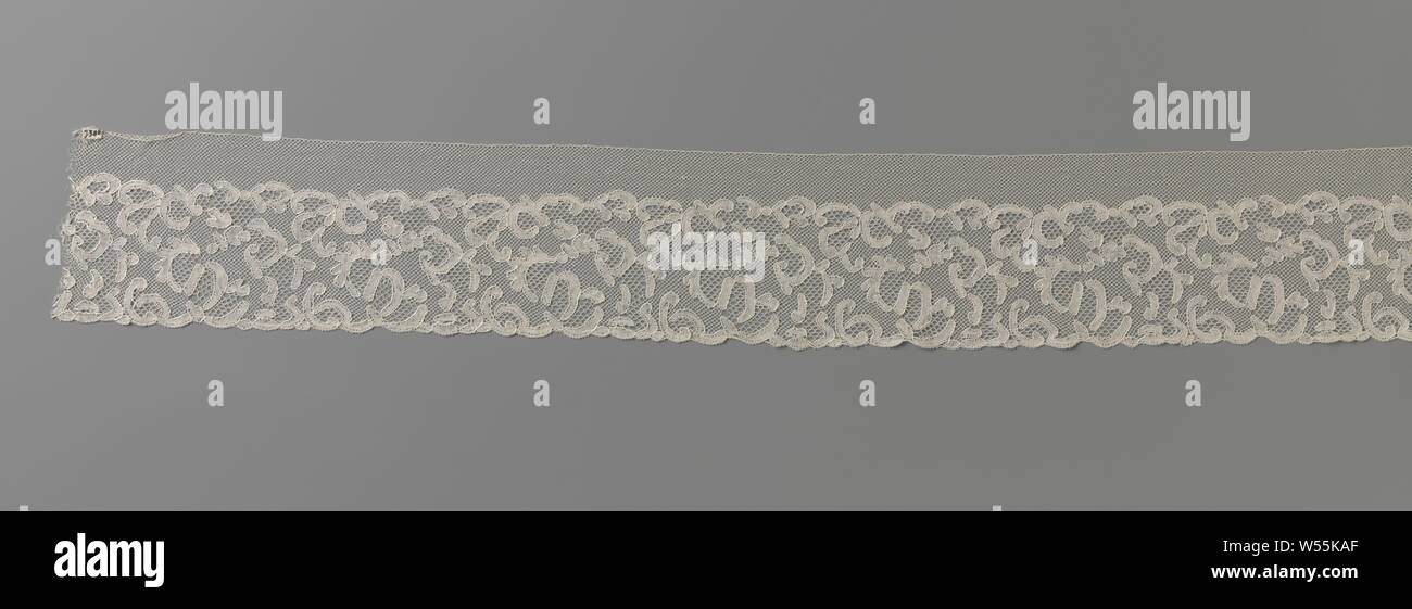 Strip of spool lace with sunken ornament Natural spool of lace strip Parisian lace. There is a broad path of wooden c volute leaves and other curved shapes that are grouped in a