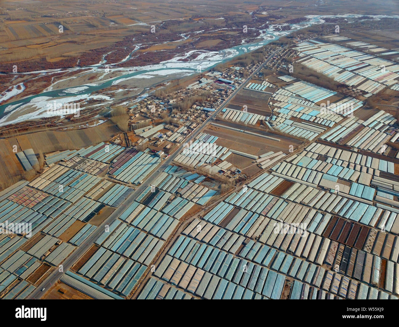 Aerial view of the greenhouses lined up in rows in Hejing county ...