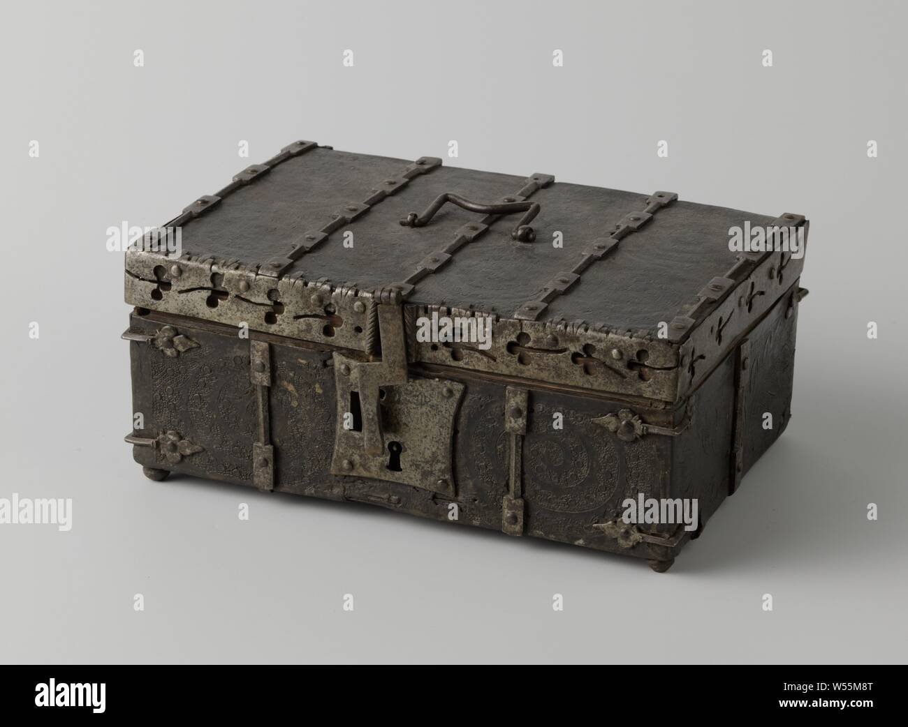 Case, A case with iron fittings, round lid, standing on four legs ...