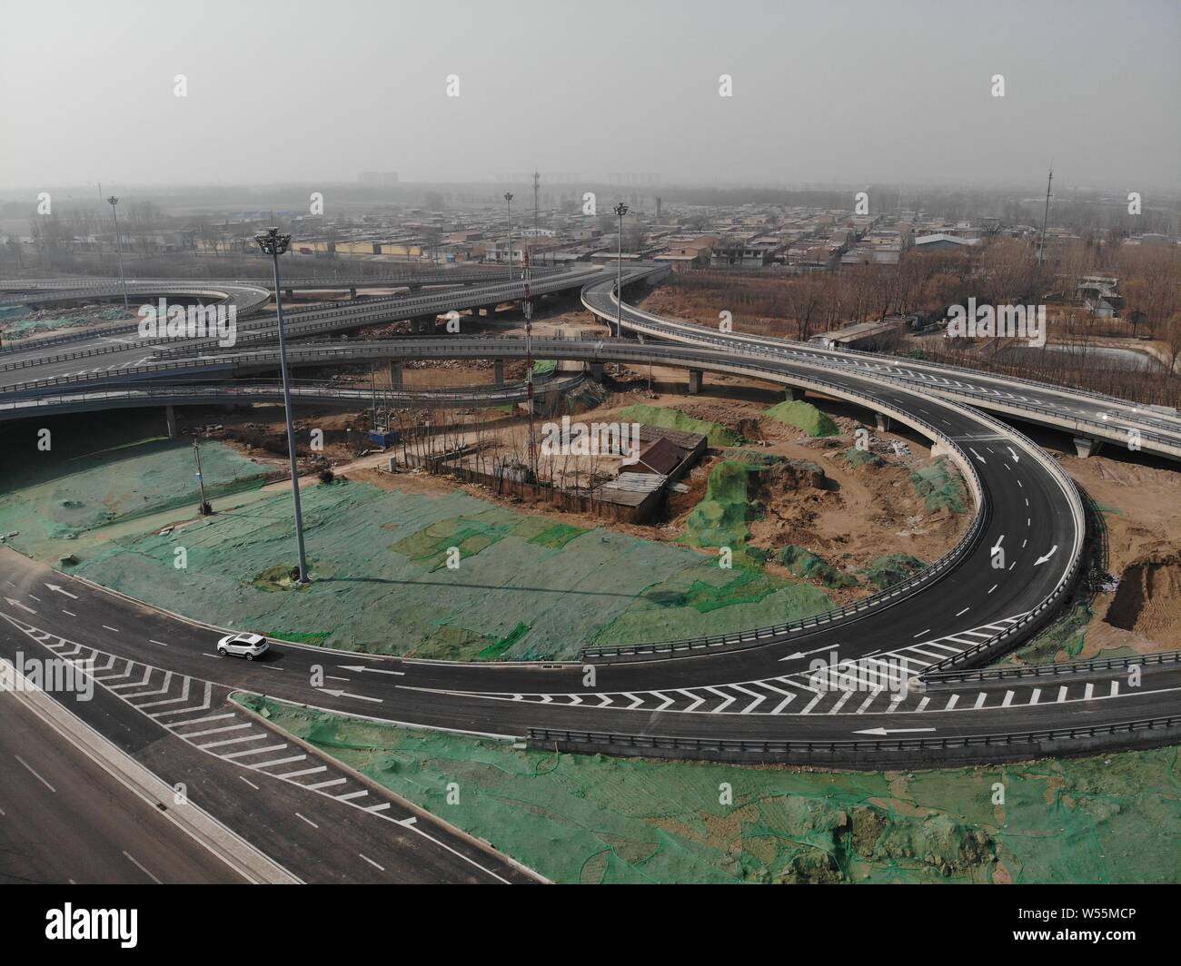 An aerial view of the nail house, which stands in the middle of circled ...